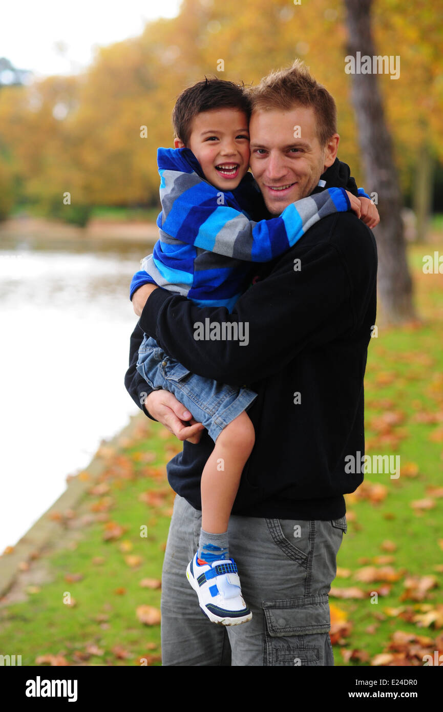 Father carrying child in arms hi-res stock photography and images - Alamy