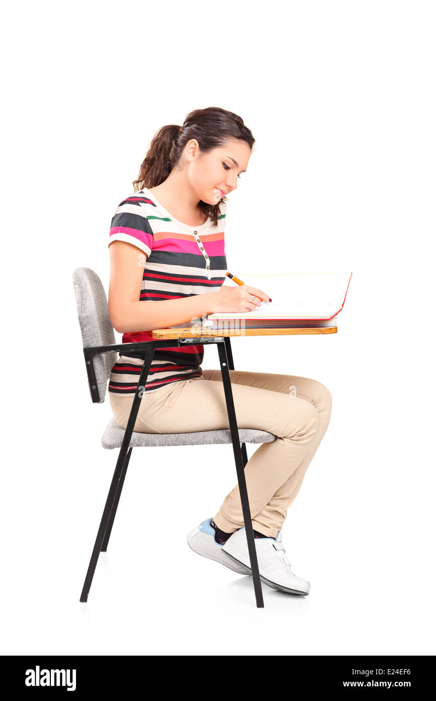 Girl writing in notebook in class Cut Out Stock Images & Pictures - Alamy