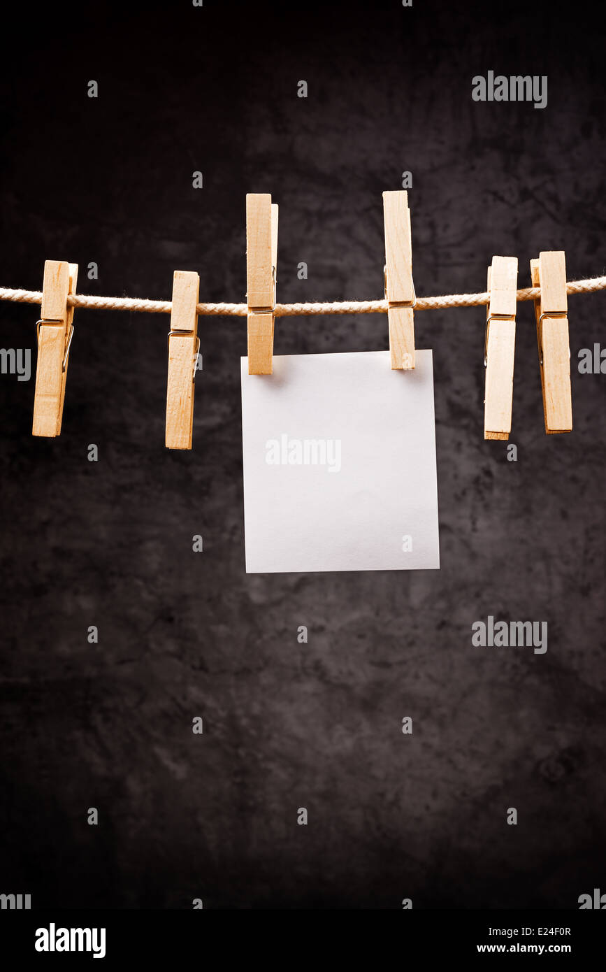 Blank note paper hanging on rope with clothes pins, copy space for your ...