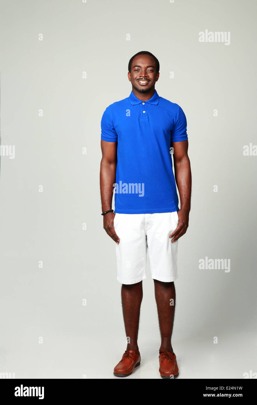 Full length portrait of a smiling african man on gray background Stock ...