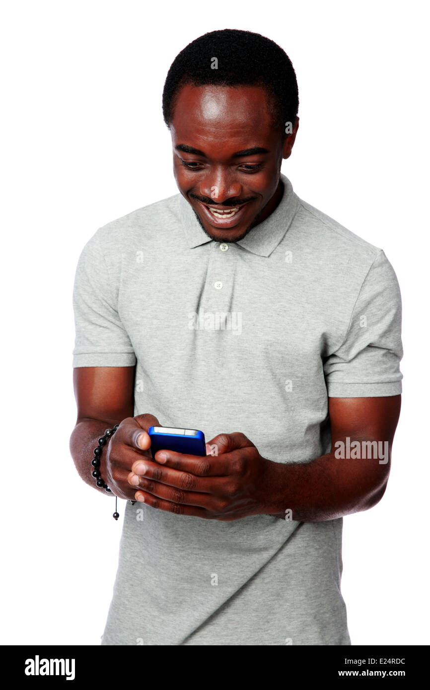 Portrait of a happy african man using smartphone over white background ...