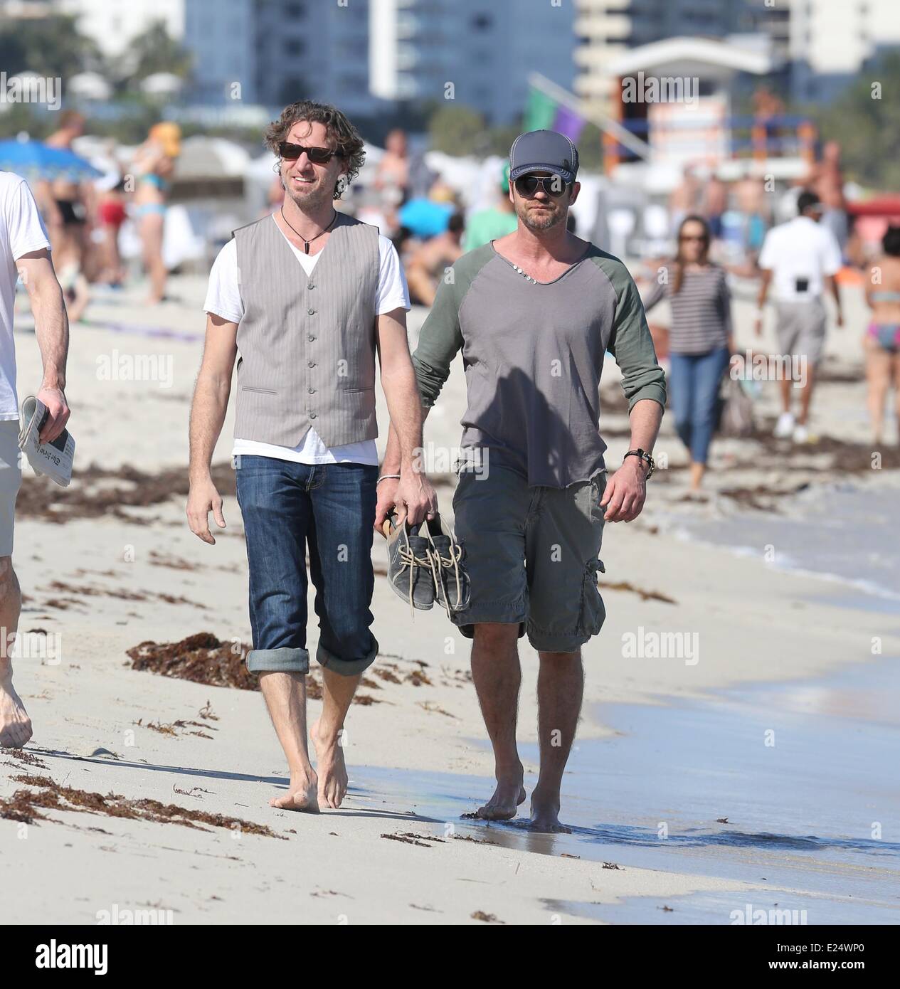 Gerard Butler enjoys a walk barefoot along Miami Beach accompanied by ...