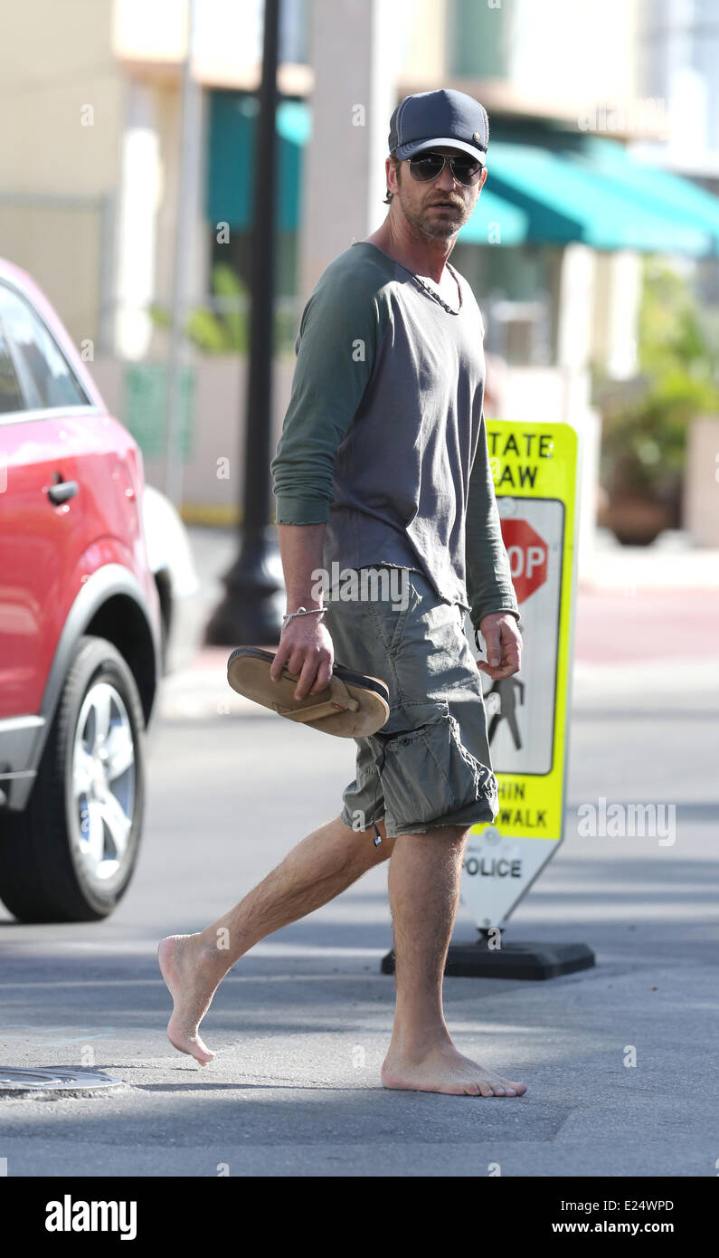 Gerard Butler enjoys a walk barefoot along Miami Beach accompanied by ...