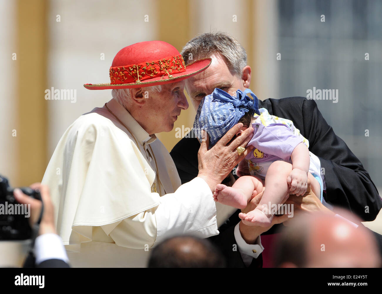 Pope Benedict XVI attends the weekly general audience wearing a red hat ...
