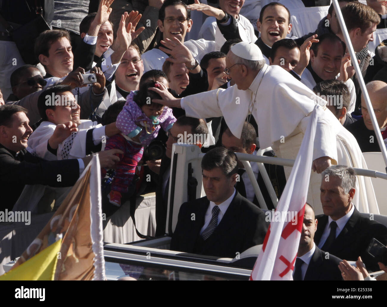 Pope Francis waves to the crowd from the papalmobile during his ...