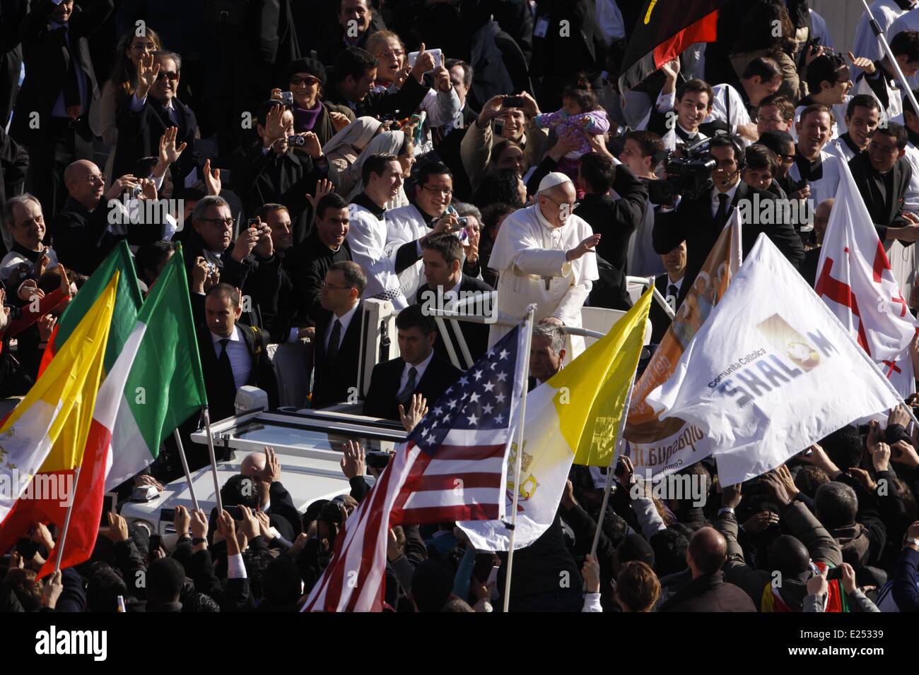 Pope Francis waves to the crowd from the papalmobile during his ...