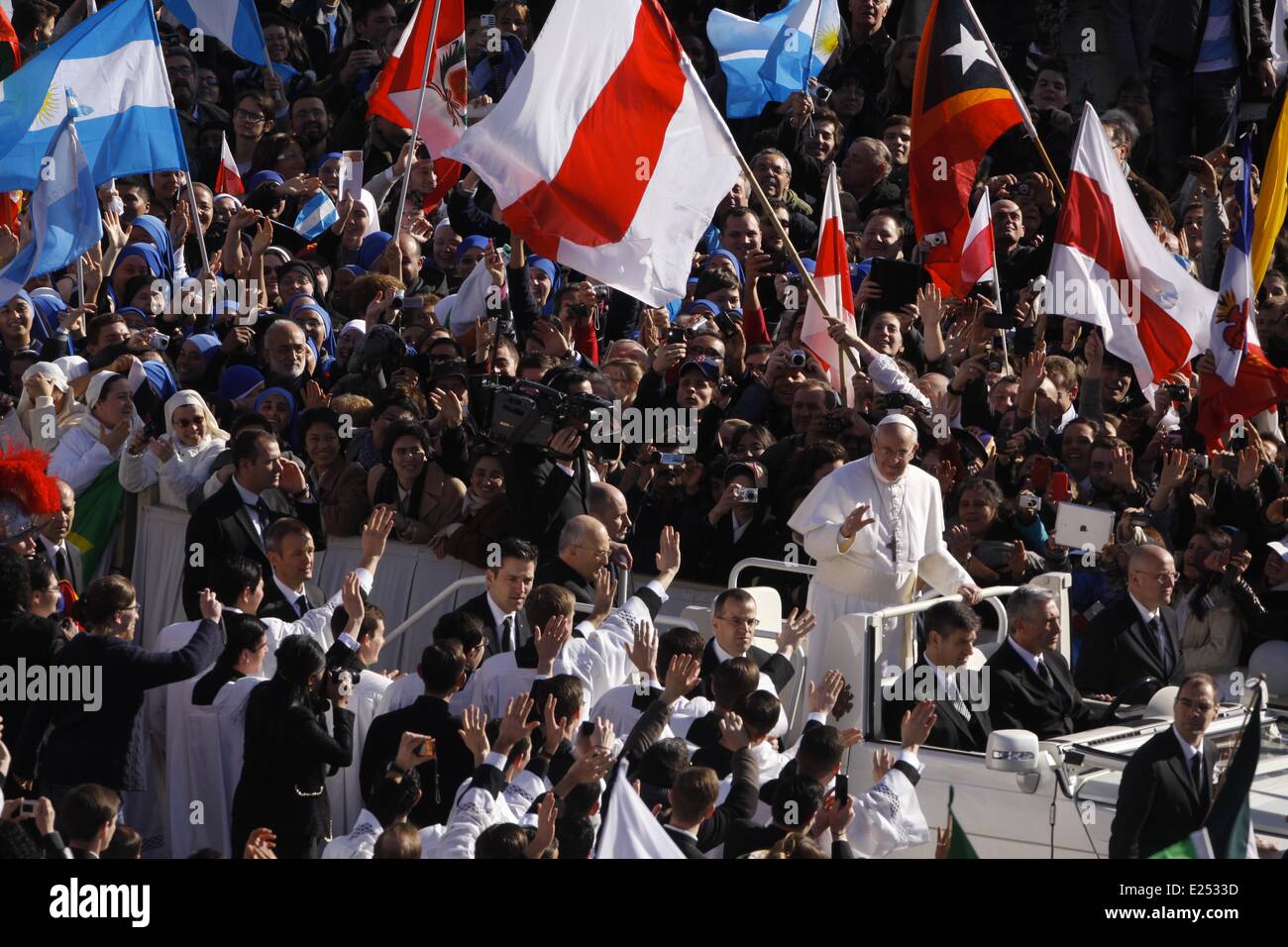 Pope Francis waves to the crowd from the papalmobile during his ...