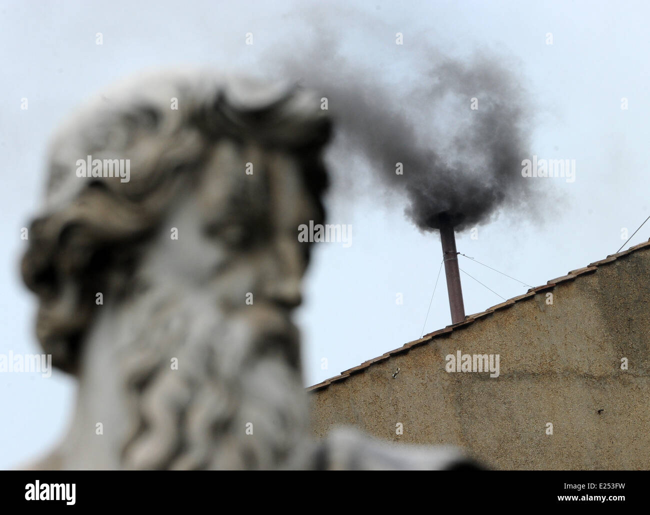 Black smoke rises from the chimney of the Sistine Chapel to indicate a new Pope has yet to be ...