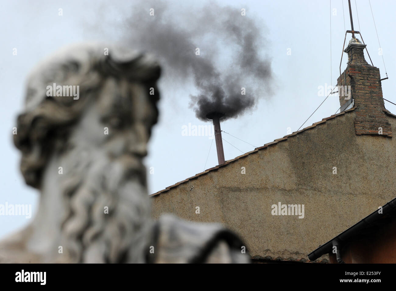 Black smoke rises from the chimney of the Sistine Chapel to indicate a ...