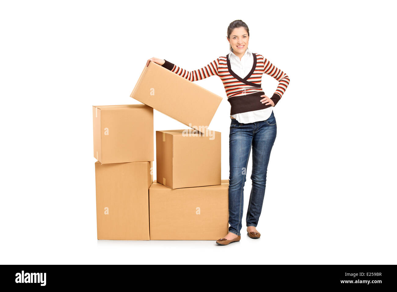 Full length portrait of a woman standing next to a pile of carton boxes ...