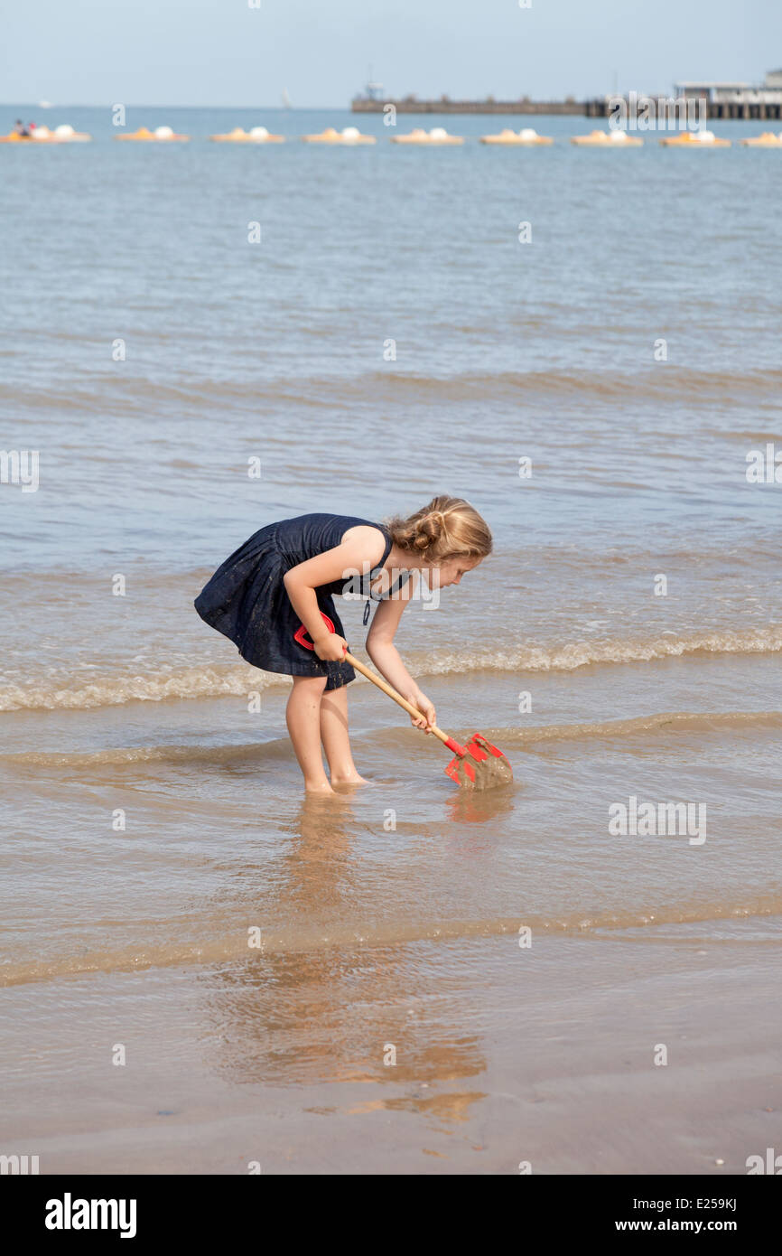 Child digging in the sand with spade hi-res stock photography and ...