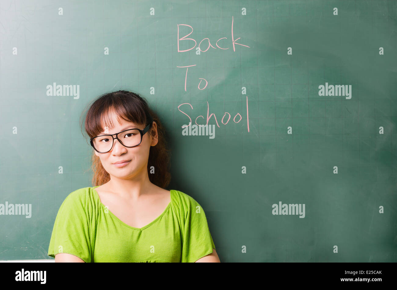 Beauty teacher standing next to a blackboard Stock Photo - Alamy