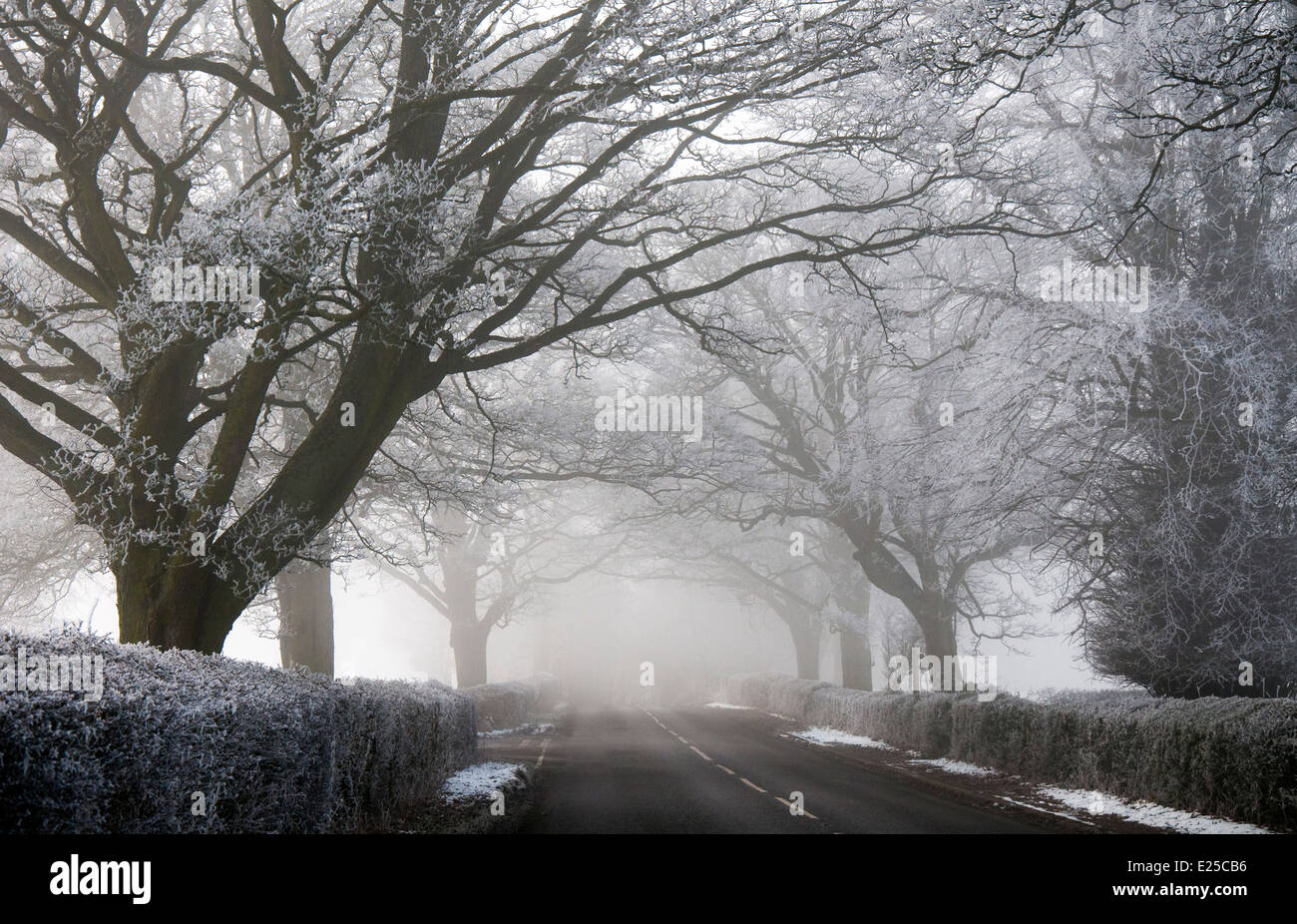 Winter snow and mist on a road in the Peak District, Derbyshire England ...