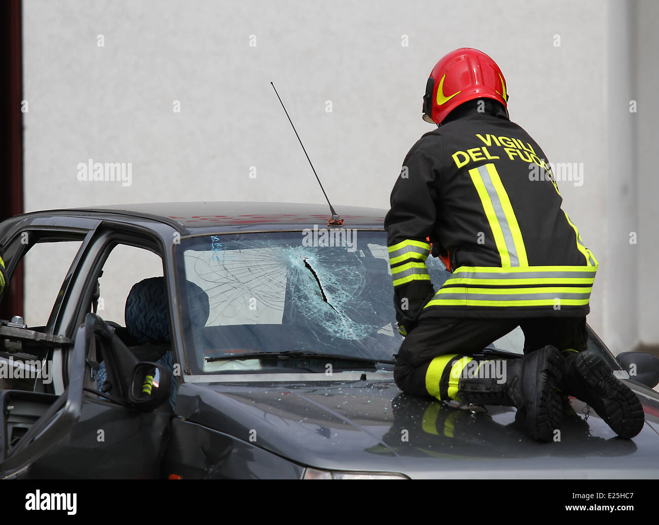 Italian fireman while breaks the glass windshield broken car to rescue ...