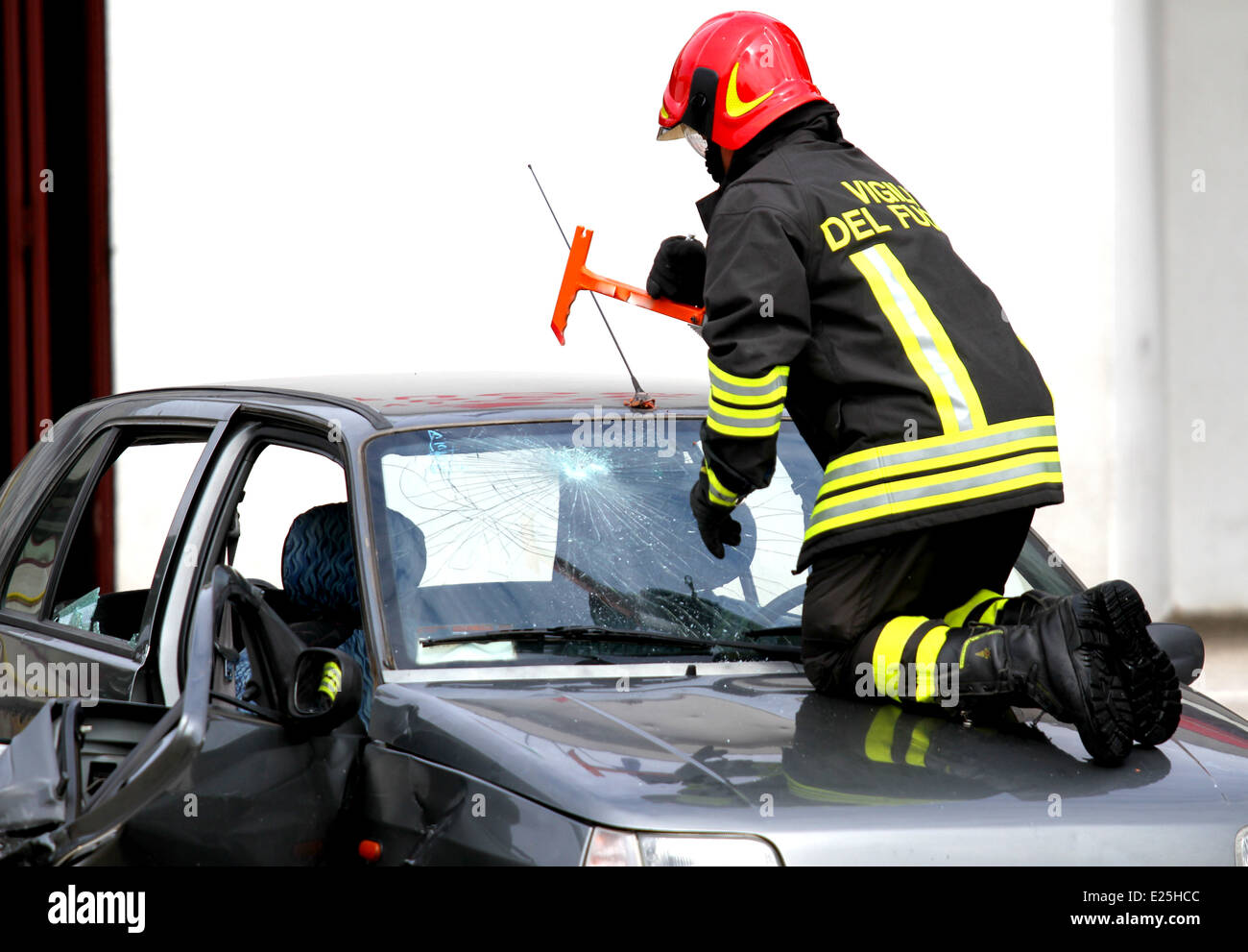 Fire Chief breaks the windshield of the car with a special hammer Stock ...