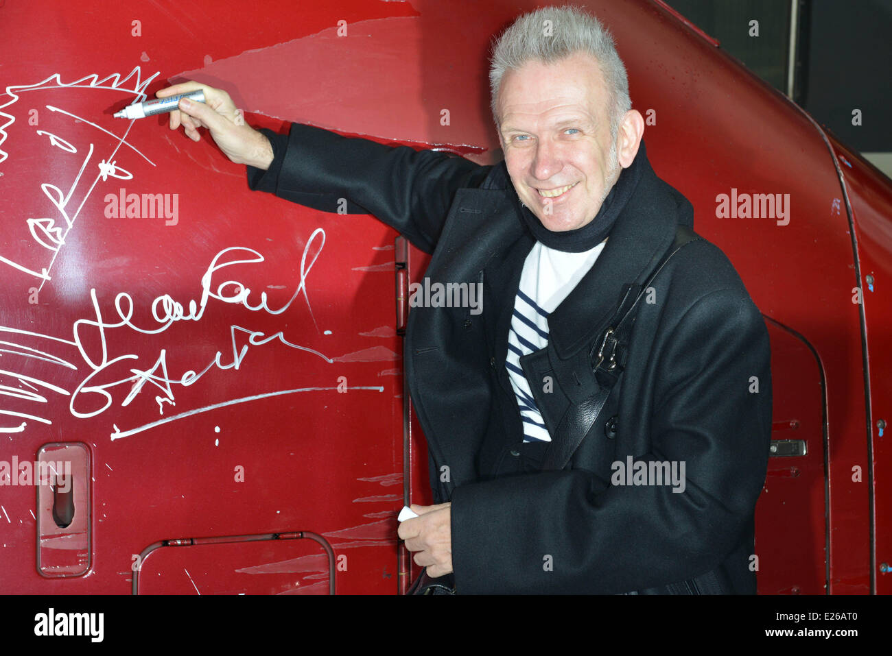 French designer Jean-Paul Gaultier signs a drawing and his autograph on ...