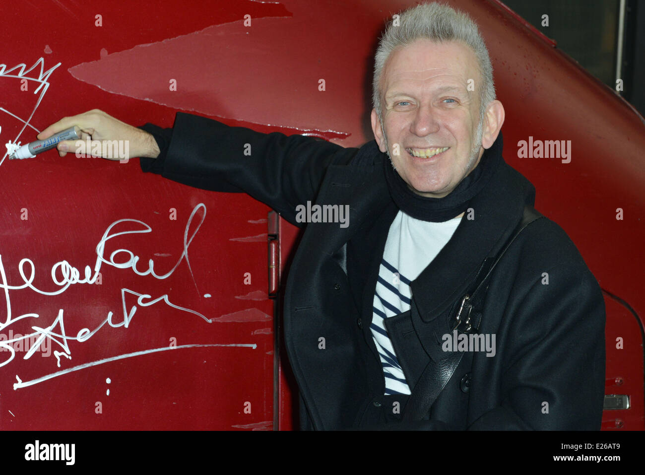 French designer Jean-Paul Gaultier signs a drawing and his autograph on ...