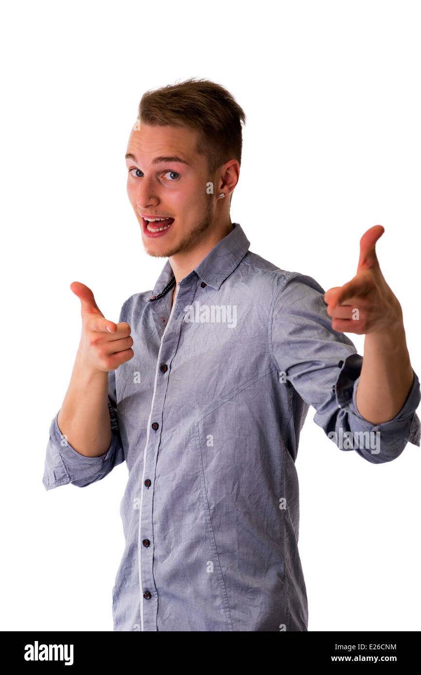 Happy attractive young man pointing fingers at camera with cool gesture ...