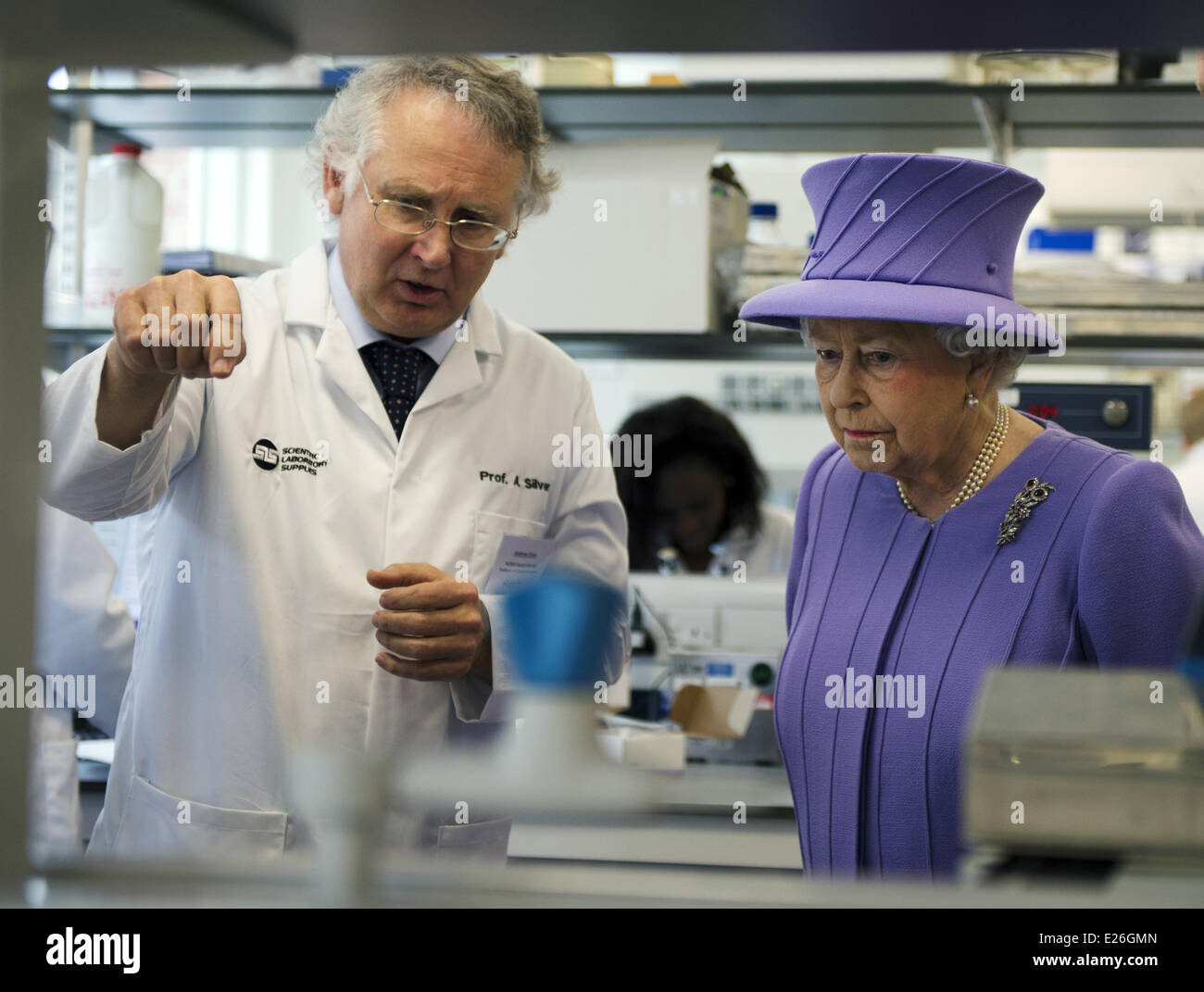 Queen Elizabeth II speaks with a Professor during a visit to the new ...