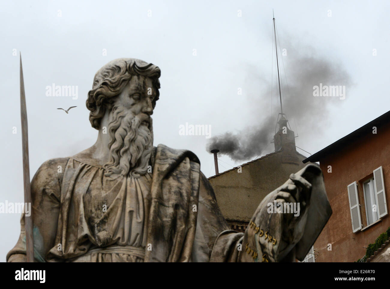 Black smoke rises from the chimney of the Sistine Chapel to indicate a ...