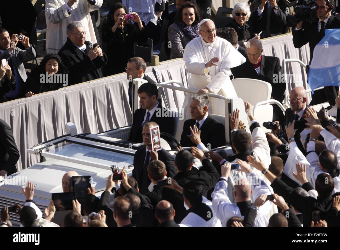 Pope Francis waves to the crowd from the papalmobile during his ...