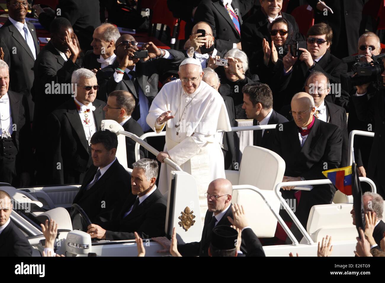 Pope Francis waves to the crowd from the papalmobile during his ...