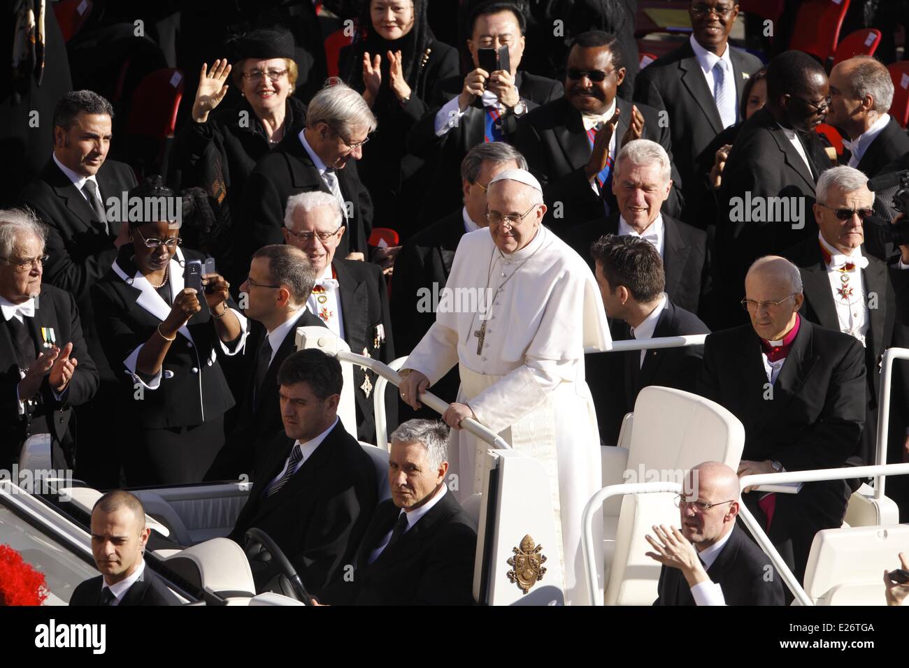 Pope Francis waves to the crowd from the papalmobile during his ...