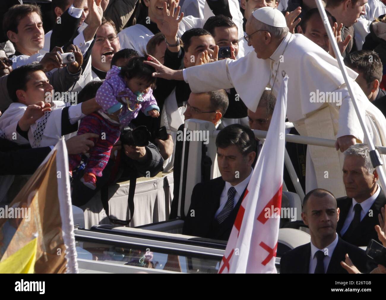 Pope Francis waves to the crowd from the papalmobile during his ...