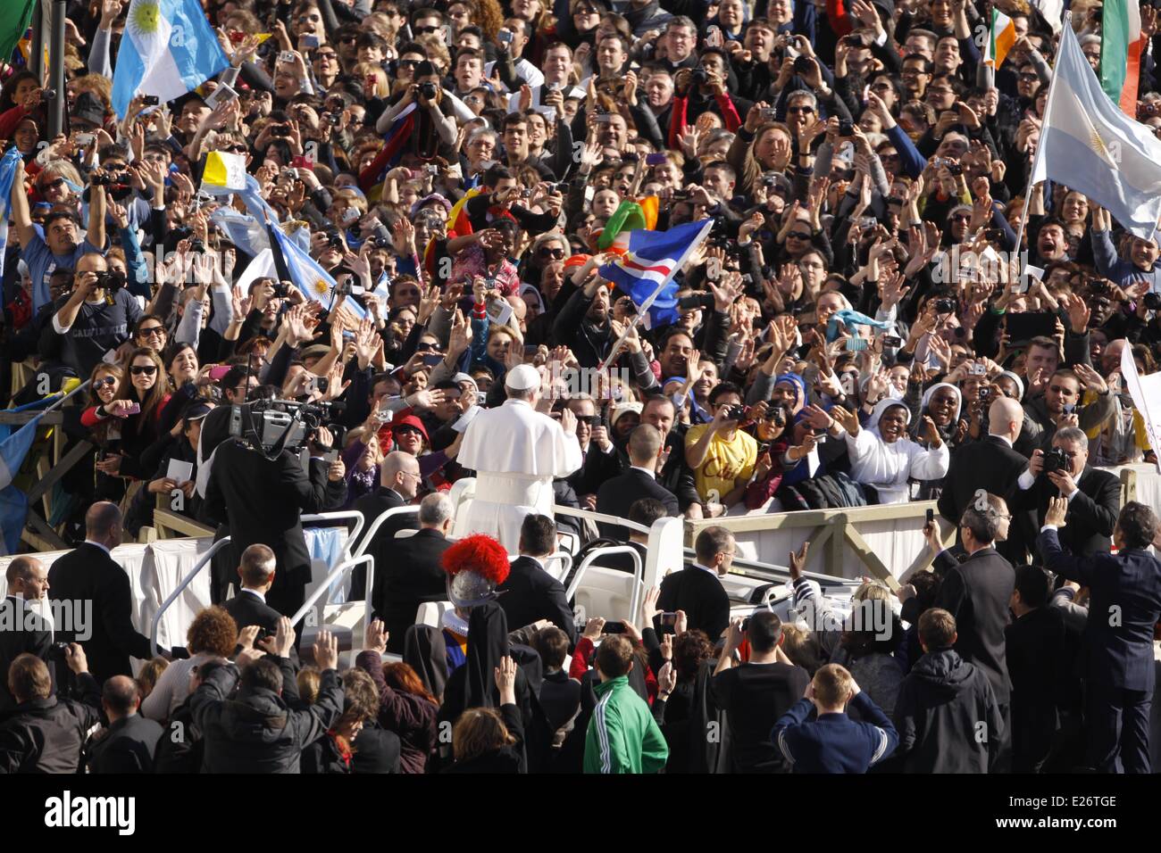 Pope Francis waves to the crowd from the papalmobile during his ...