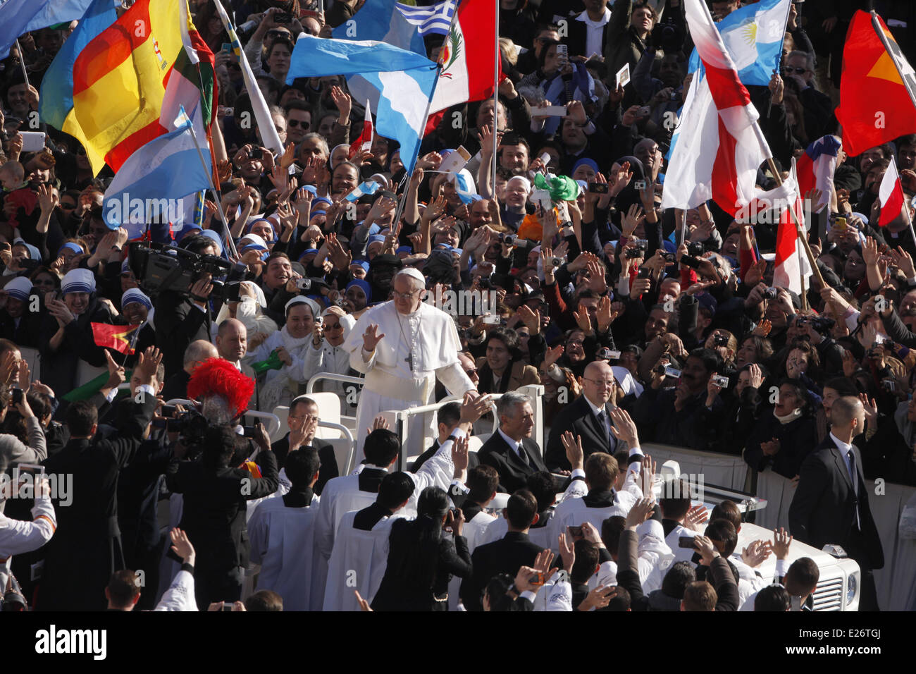 Pope Francis waves to the crowd from the papalmobile during his ...