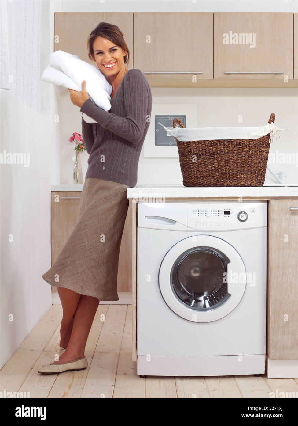 pretty smiling girl in the laundry room l Stock Photo - Alamy