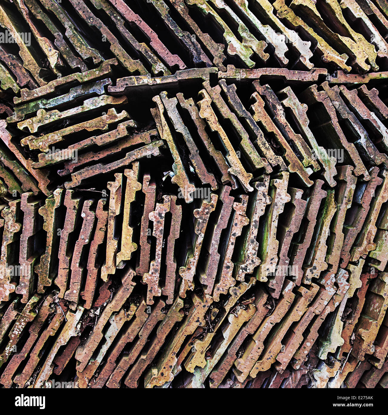 Weathered and discarded stack of unused terracotta clay roof tiles ...