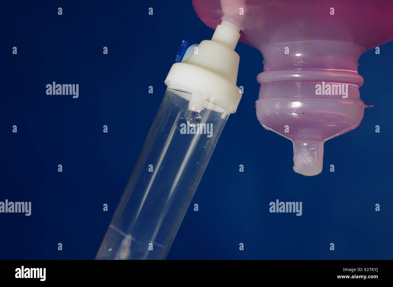 device to drip on blue background Stock Photo - Alamy