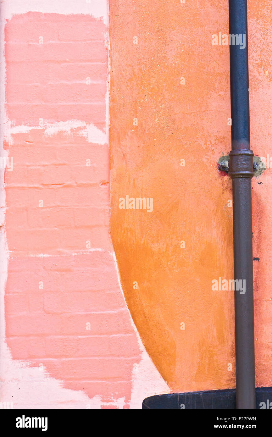 A drain pipe on an external wall with painted shades of color Stock ...