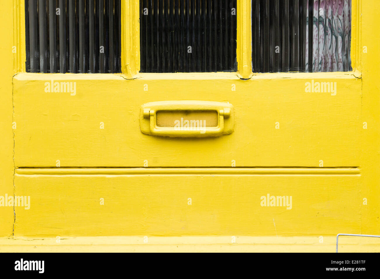 Letterbox in a yellow front door Stock Photo - Alamy