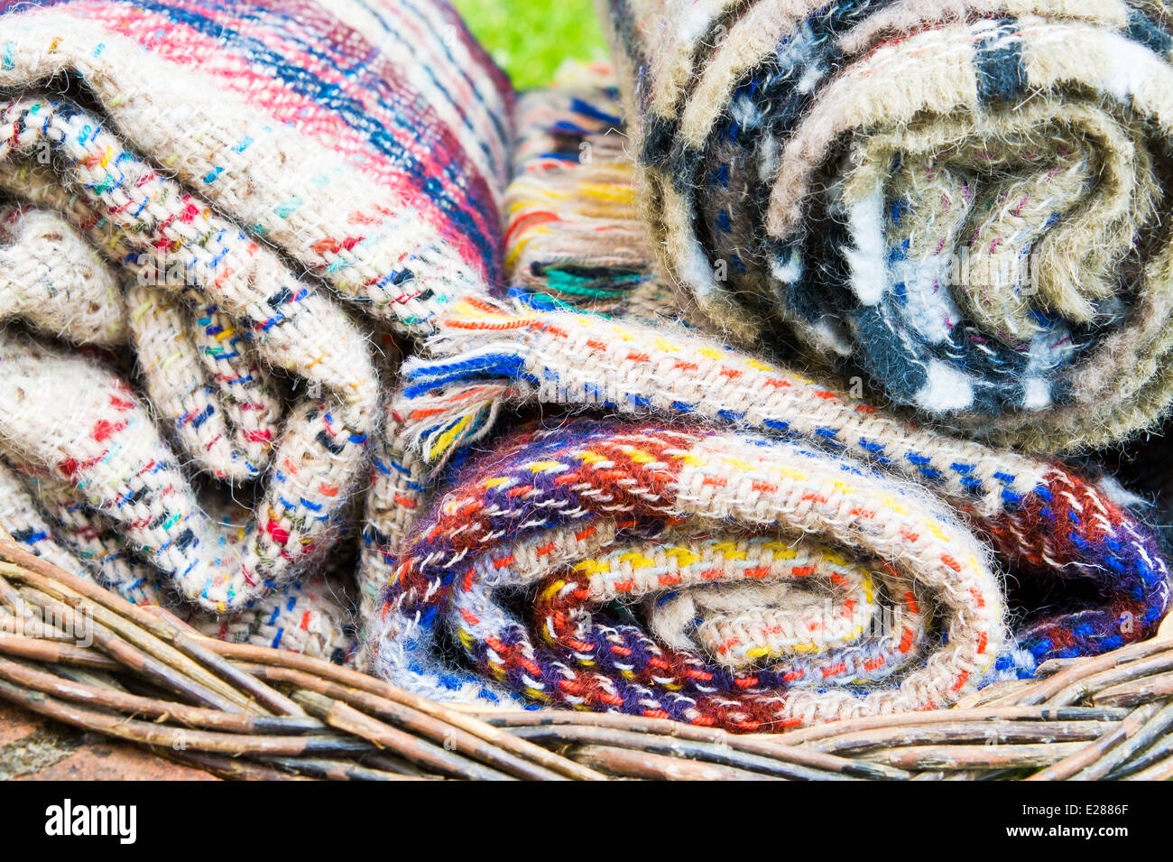 Rolled up wool blankets in a basket Stock Photo - Alamy