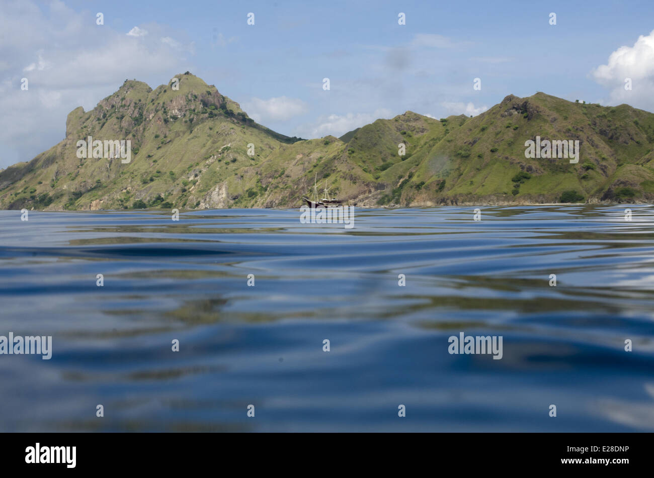 View of coastline with hills and ship from surface of sea, Mobula Point ...