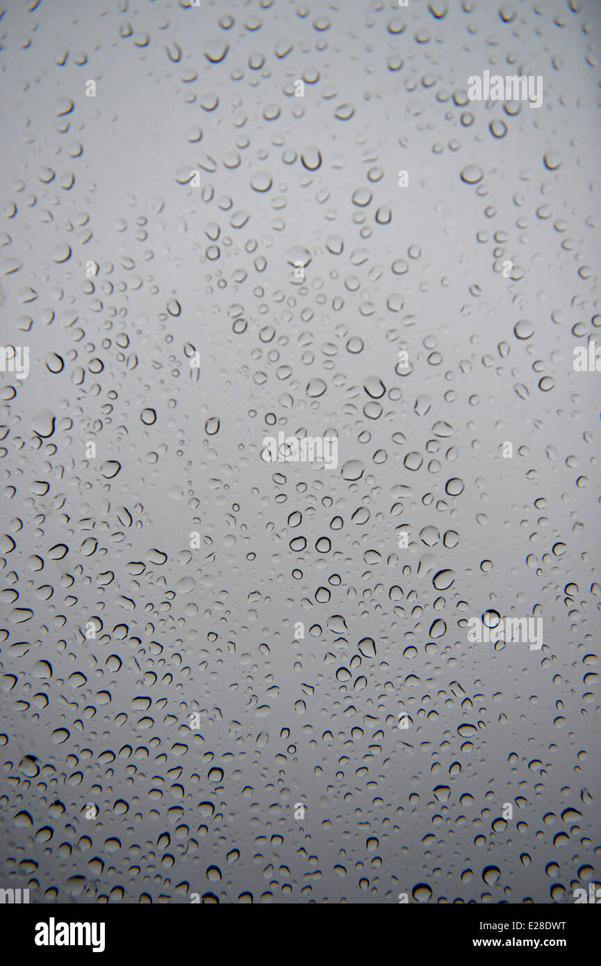 A close up shot of rain droplets on a window Stock Photo - Alamy