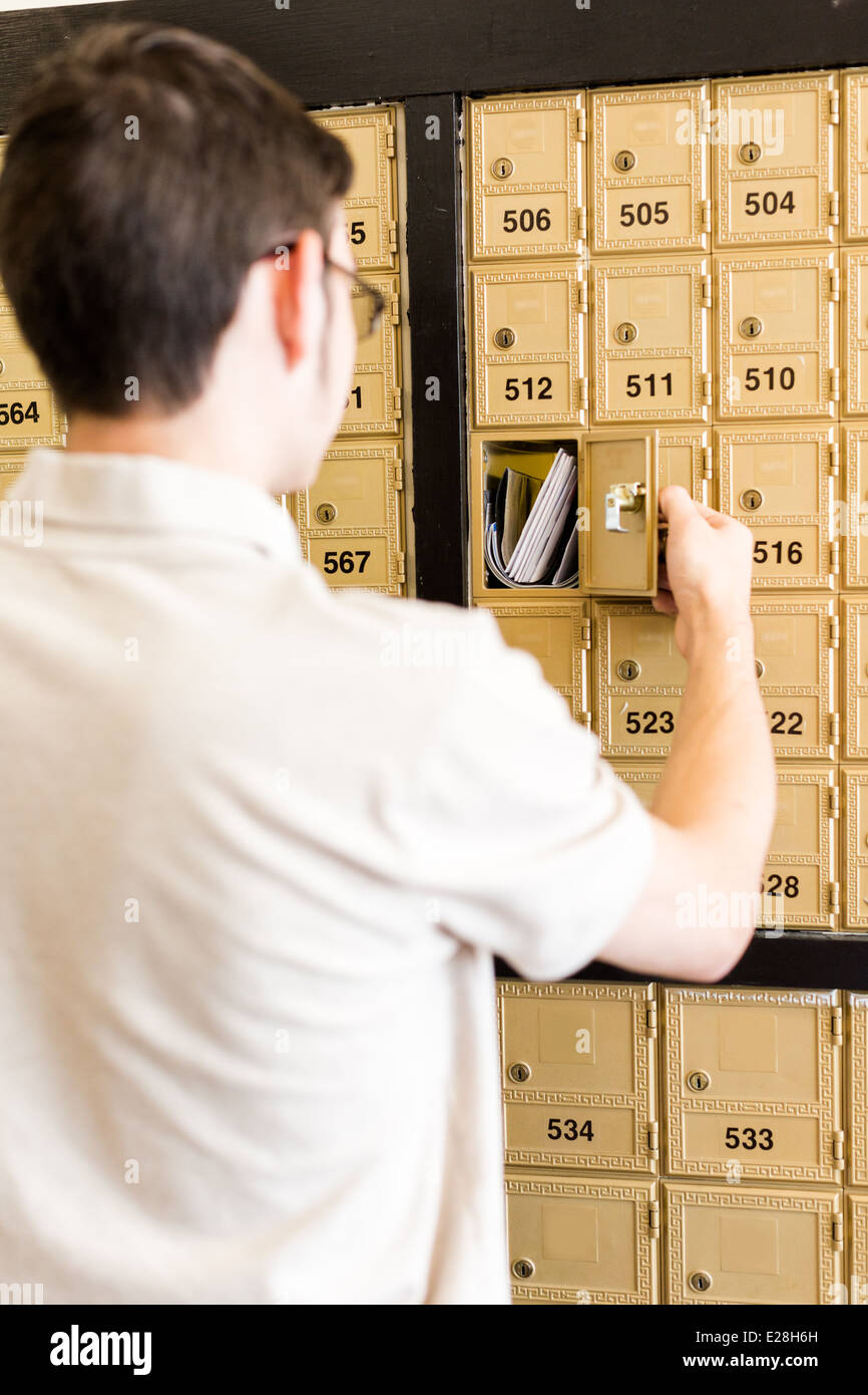 College student checking mail at mailboxed Stock Photo - Alamy