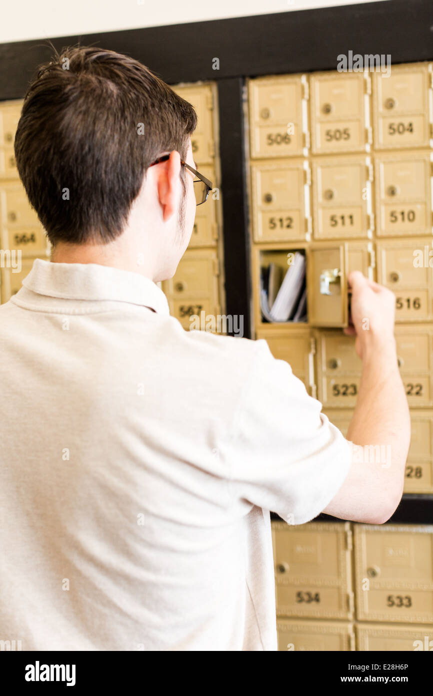 College student checking mail at mailboxed Stock Photo - Alamy