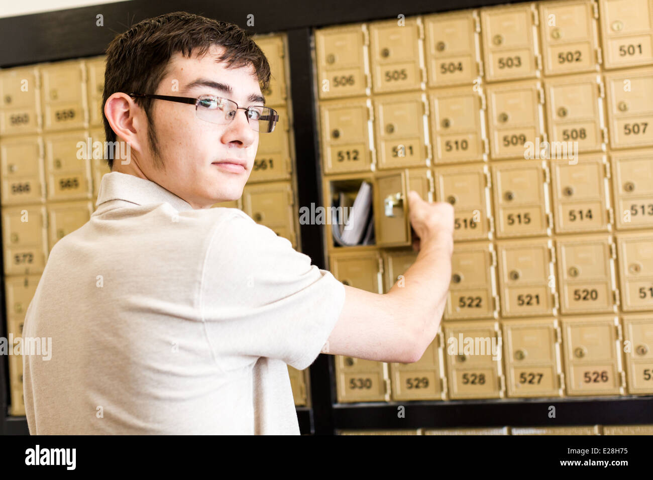 College student checking mail at mailboxed Stock Photo - Alamy
