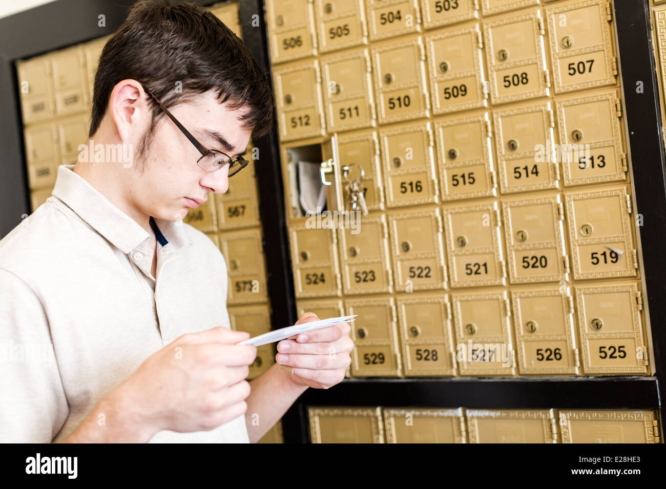 College student checking mail at mailboxed Stock Photo - Alamy