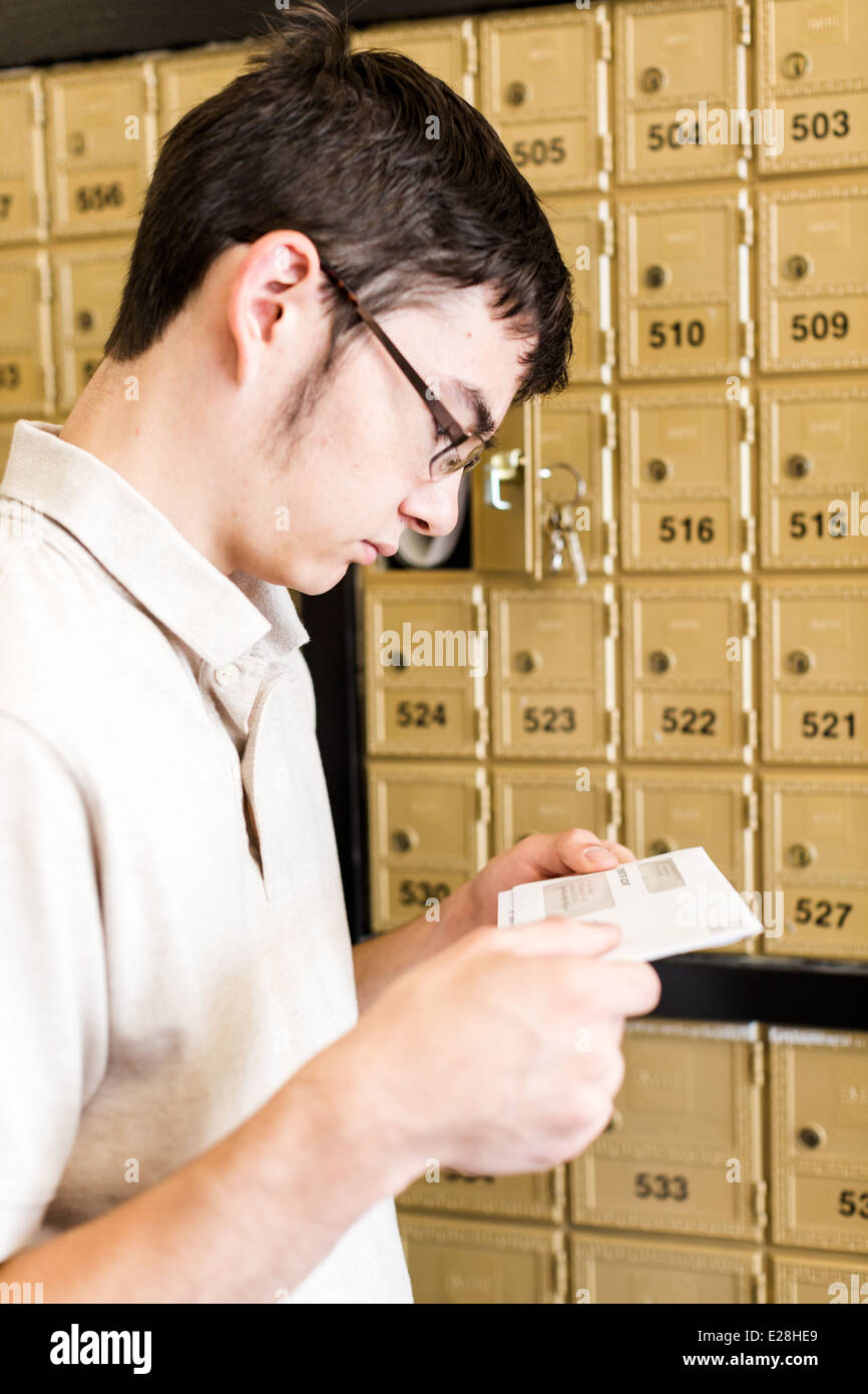 College student checking mail at mailboxed Stock Photo - Alamy