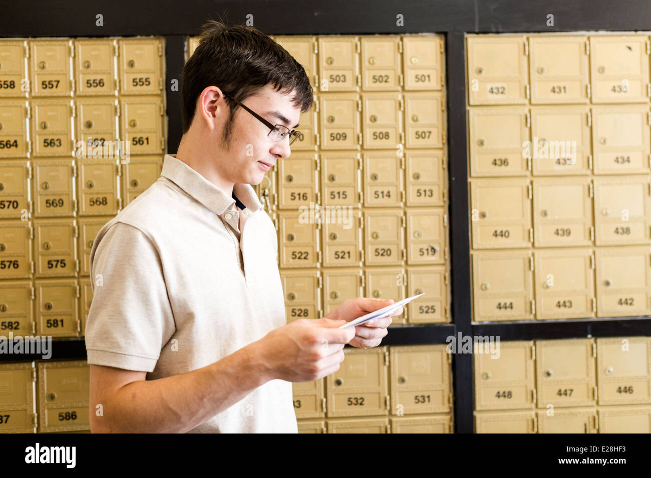 College student checking mail at mailboxed Stock Photo - Alamy