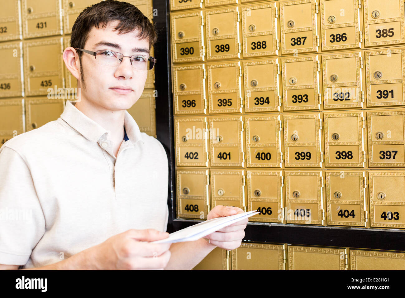 College student checking mail at mailboxed Stock Photo - Alamy