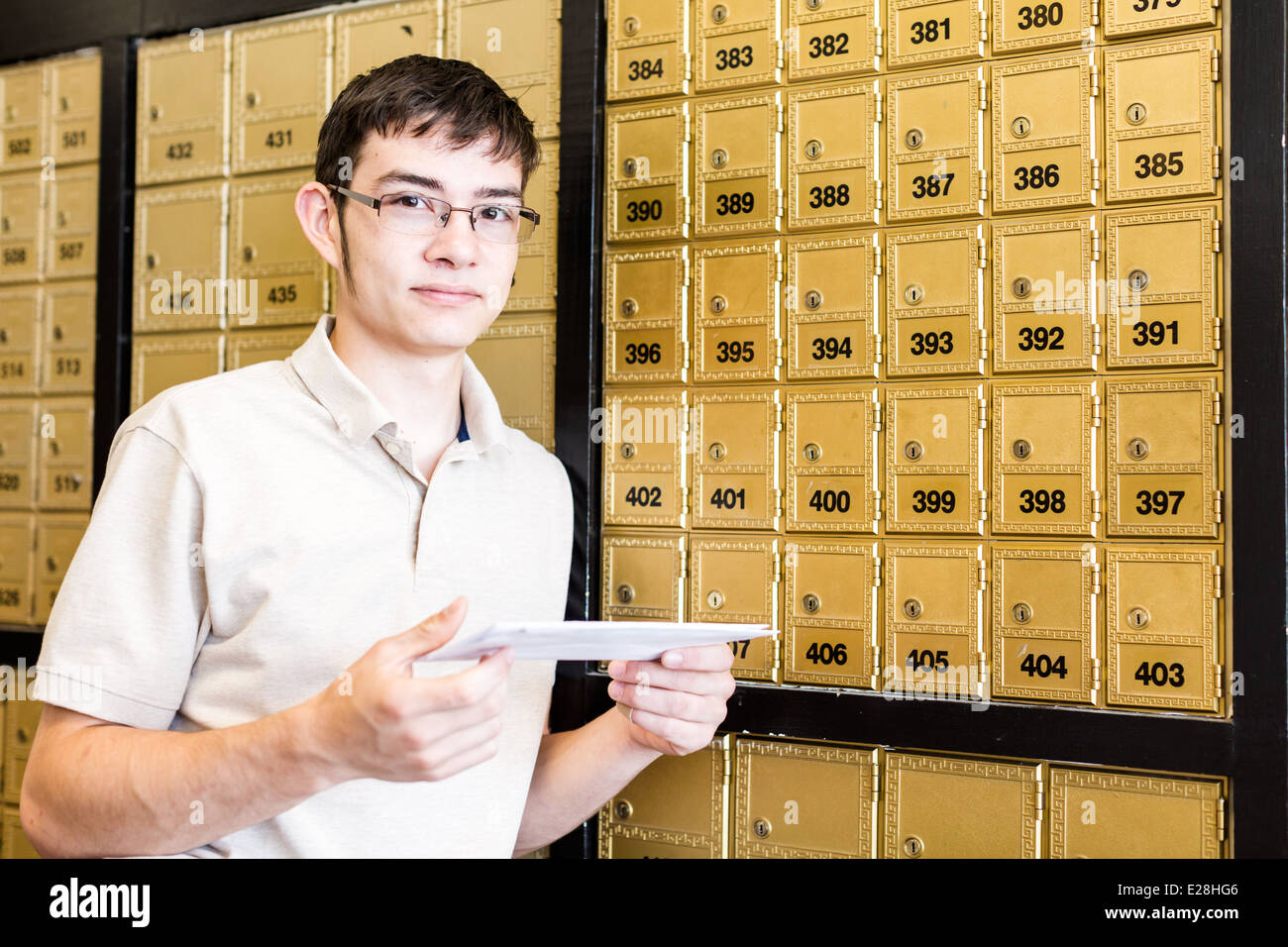 College student checking mail at mailboxed Stock Photo - Alamy
