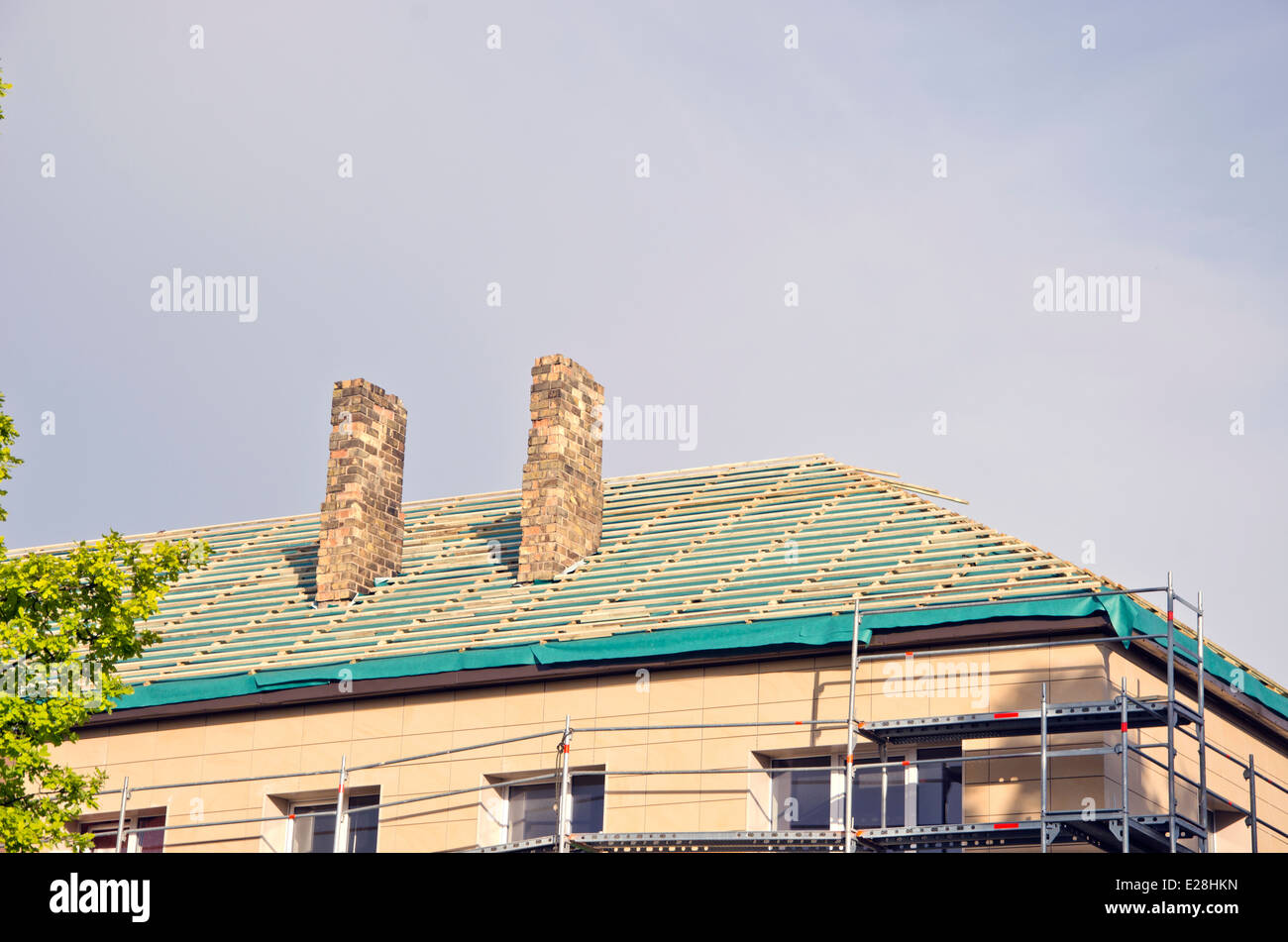 old urban house roof restoration repairing construction Stock Photo - Alamy
