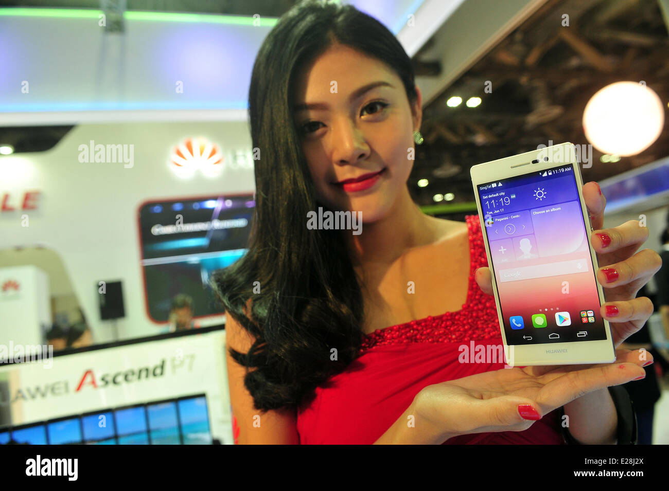 Singapore. 17th June, 2014. A model poses for photos with the latest ...