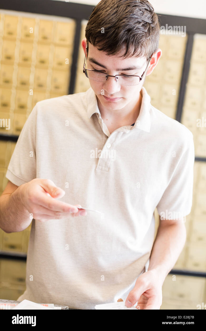 College student checking mail at mailboxed Stock Photo - Alamy