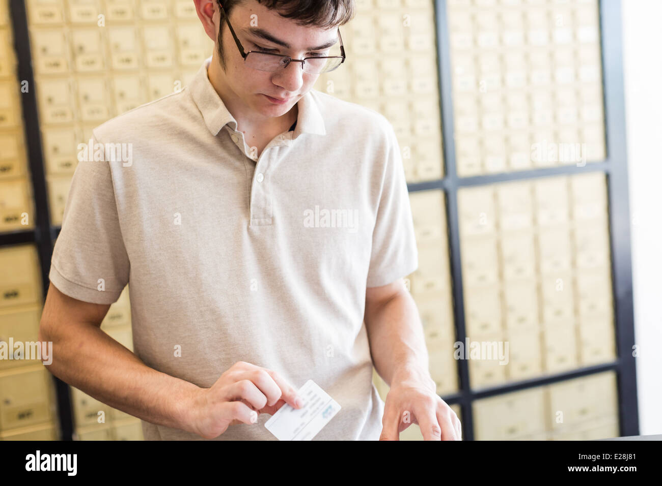 College student checking mail at mailboxed Stock Photo - Alamy